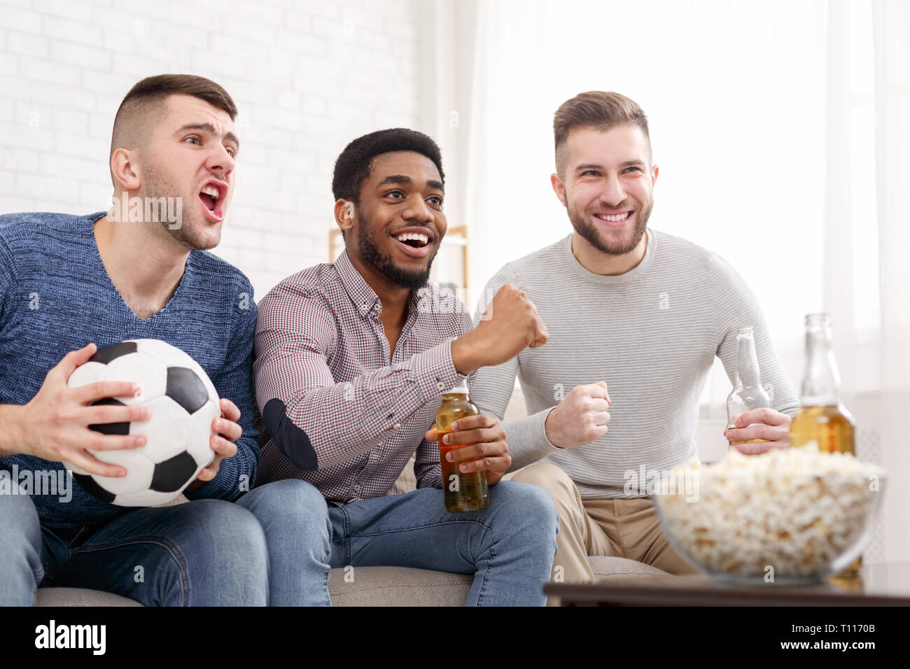 Men watching football match, cheering for favourite team Stock Photo ...
