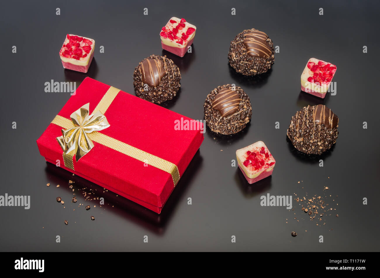 Red velvet gift box with gold ribbon on dark background, with luxury ...