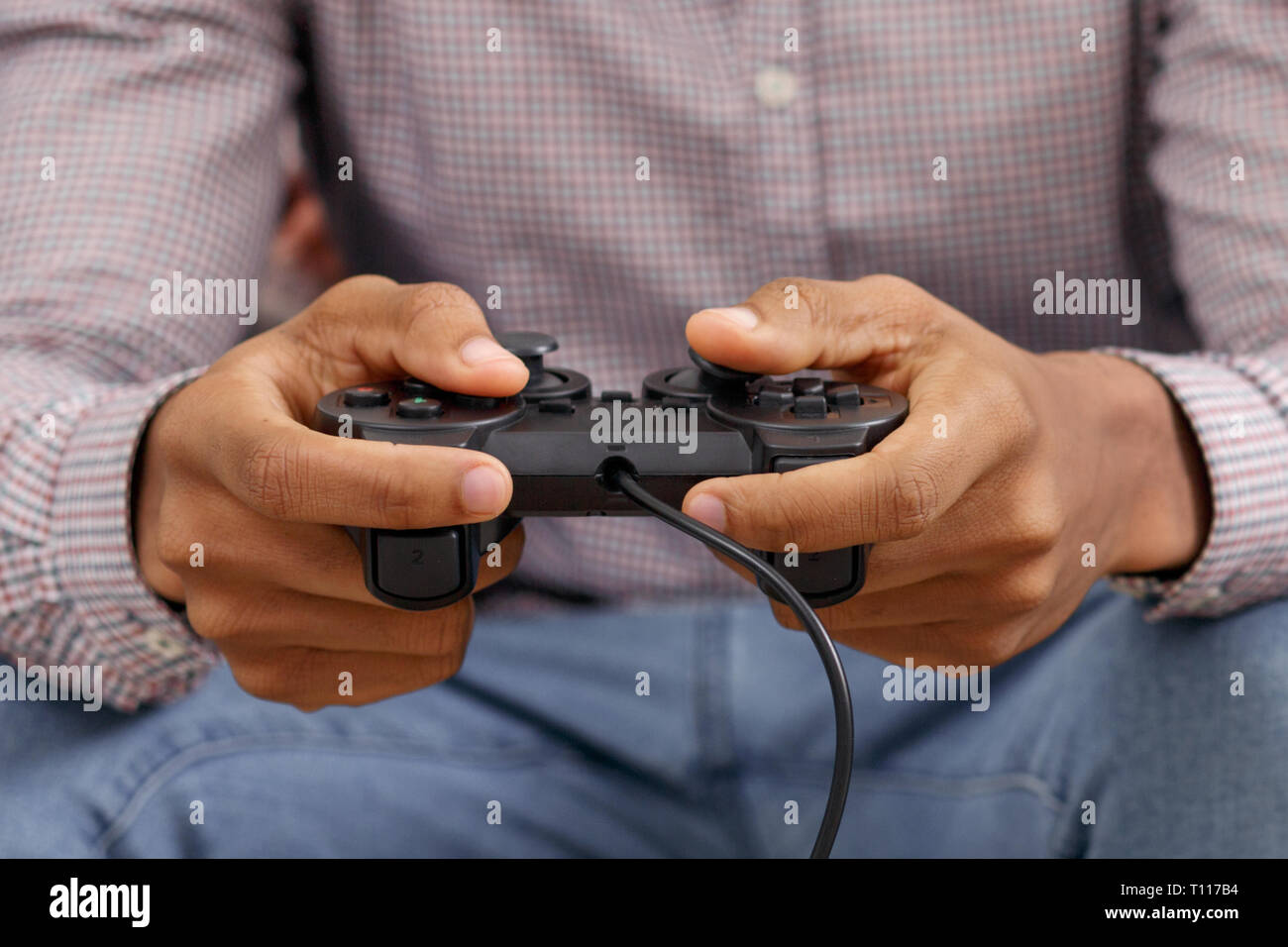 Man playing video games with joystick, closeup Stock Photo - Alamy