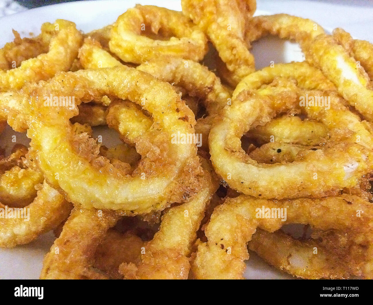 Fried slices of squid breaded in egg Stock Photo - Alamy