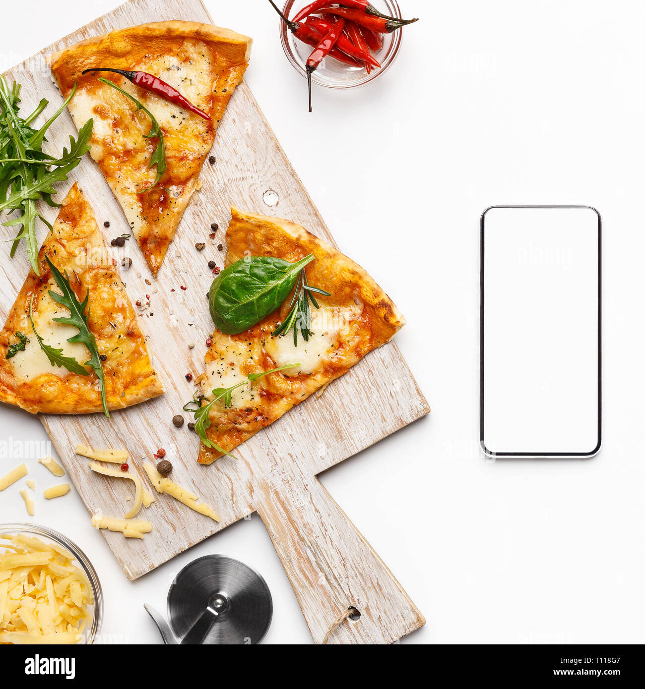 Pizza slices and smartphone with blank screen Stock Photo - Alamy