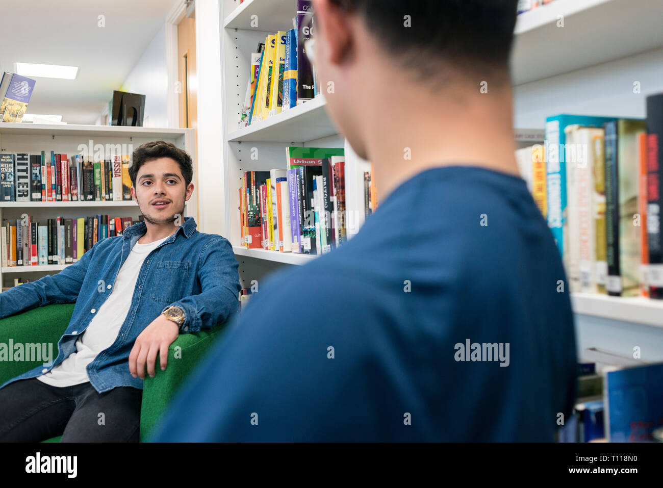 students sit and work to revise in the school / college library Stock ...