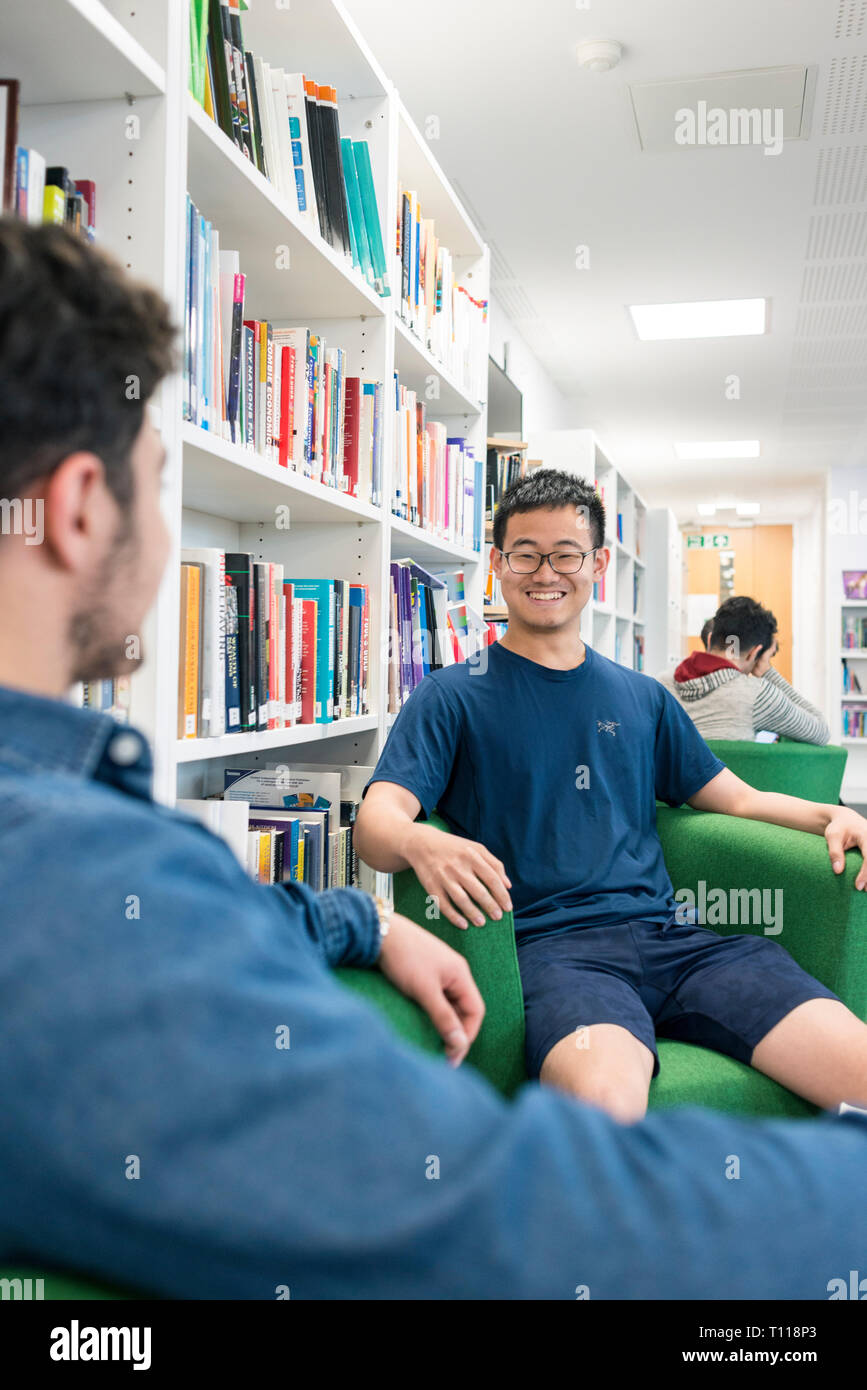 students sit and work to revise in the school / college library Stock ...