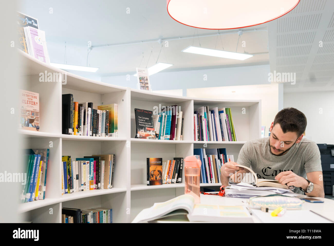 students sit and work to revise in the school / college library Stock ...