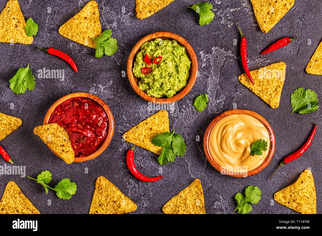 Mexican food background: guacamole, salsa, cheesy sauces with ...
