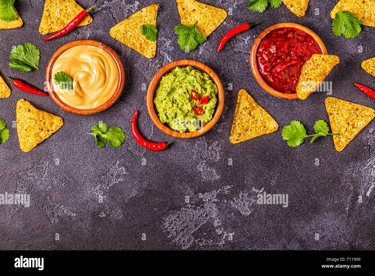 Mexican food background: guacamole, salsa, cheesy sauces with ...