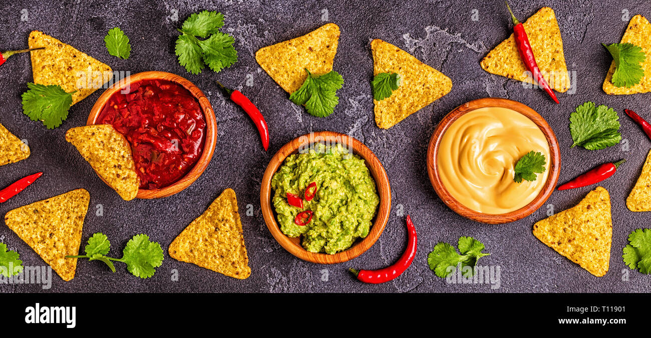 Mexican food background: guacamole, salsa, cheesy sauces with ...