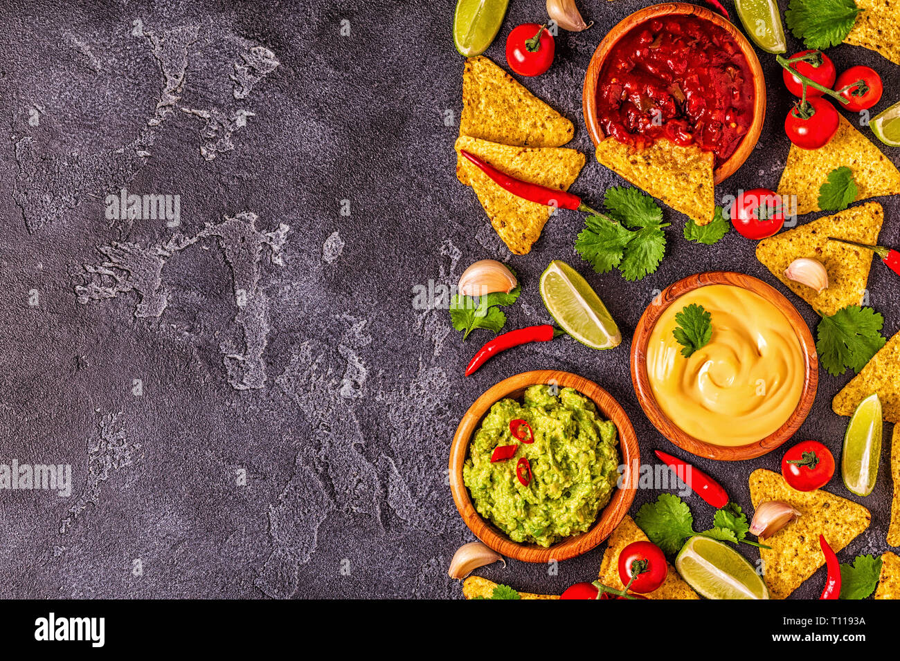 Mexican food background: guacamole, salsa, cheesy sauces with ...
