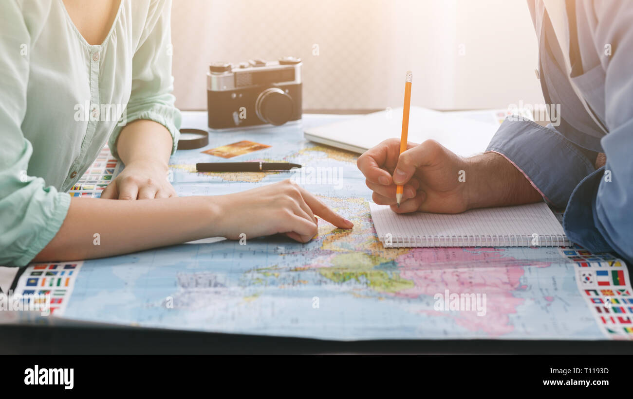 Couple planning honeymoon vacation, writing in notebook Stock Photo - Alamy