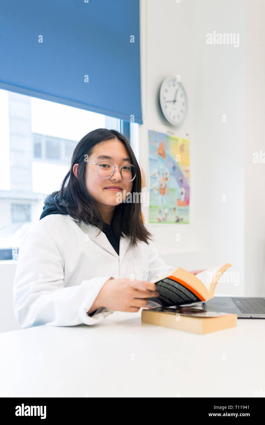 a female international asian student in the science lab of her college ...