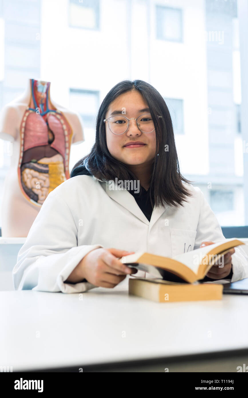 a female international asian student in the science lab of her college ...