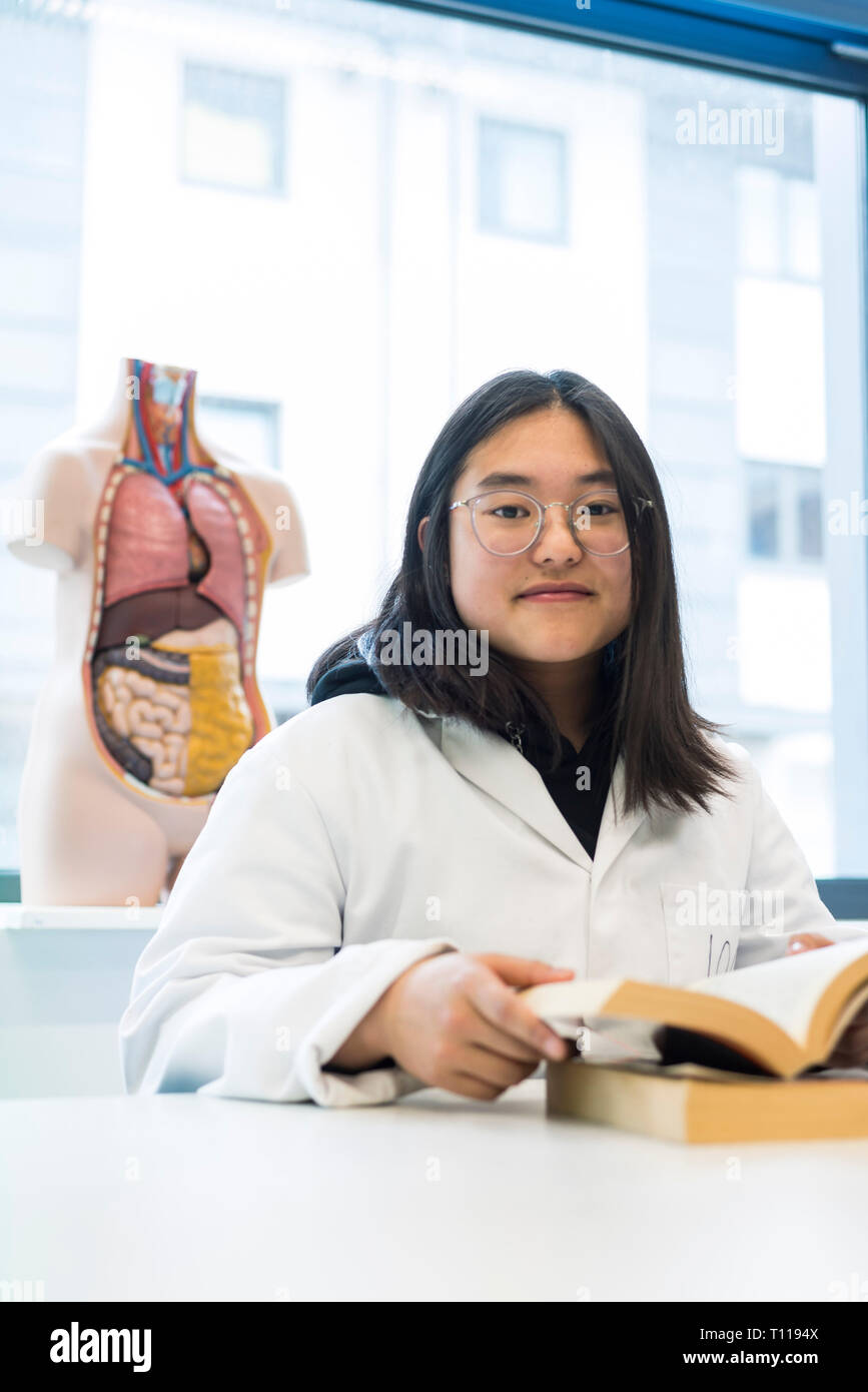 a female international asian student in the science lab of her college ...