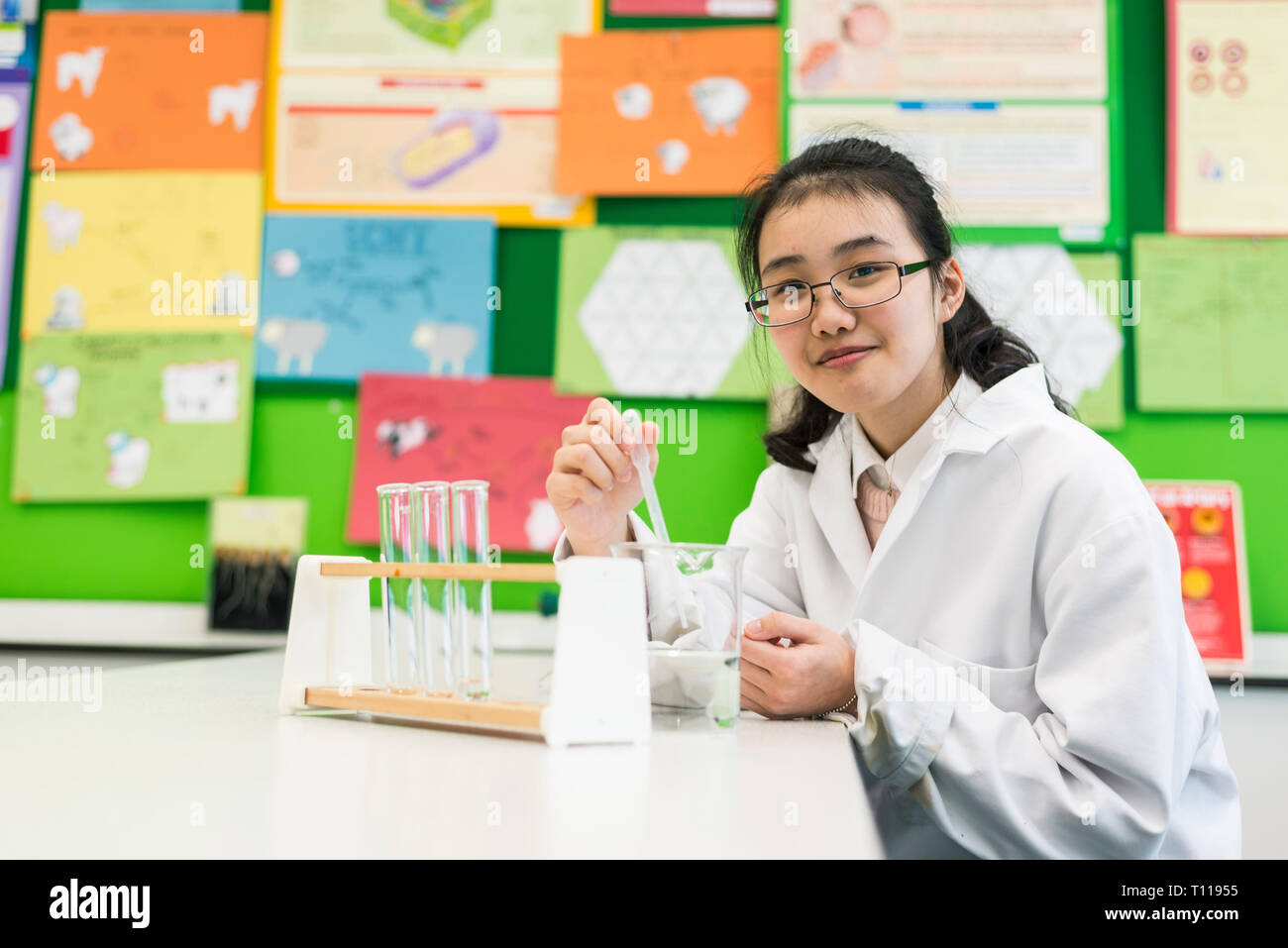 a female international asian student in the science lab of her college ...