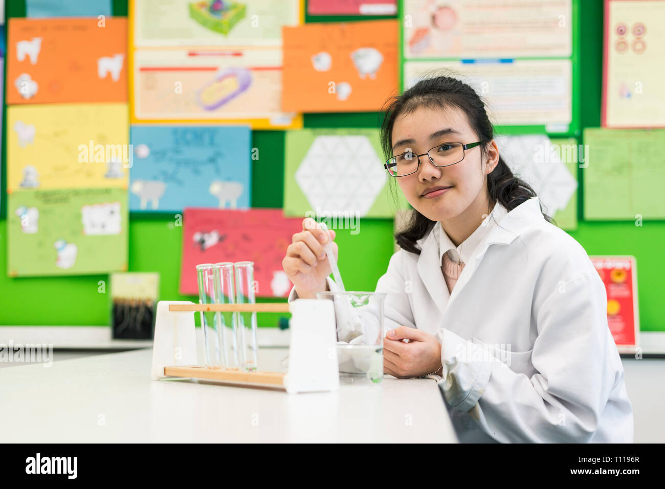 a female international asian student in the science lab of her college ...