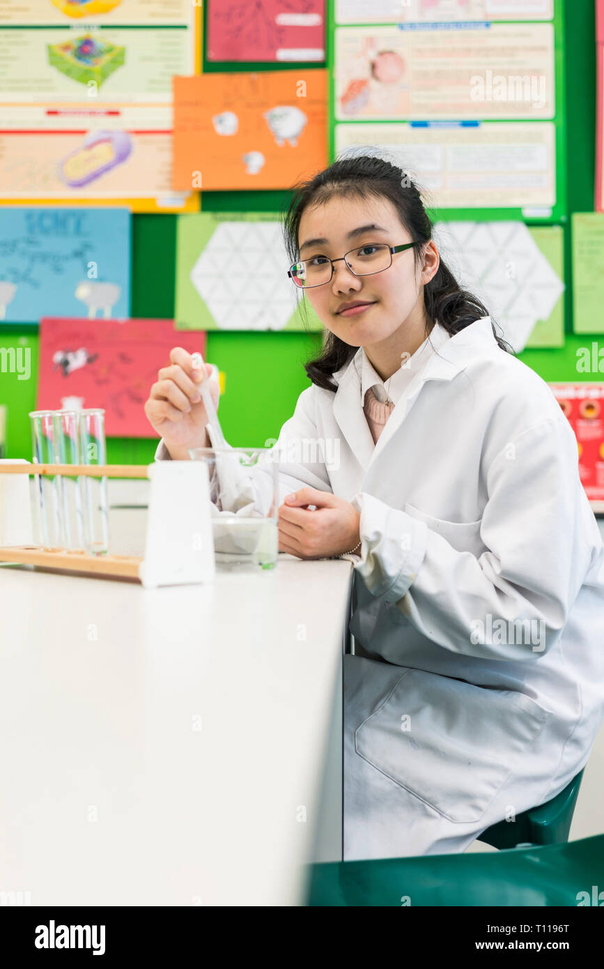 a female international asian student in the science lab of her college ...