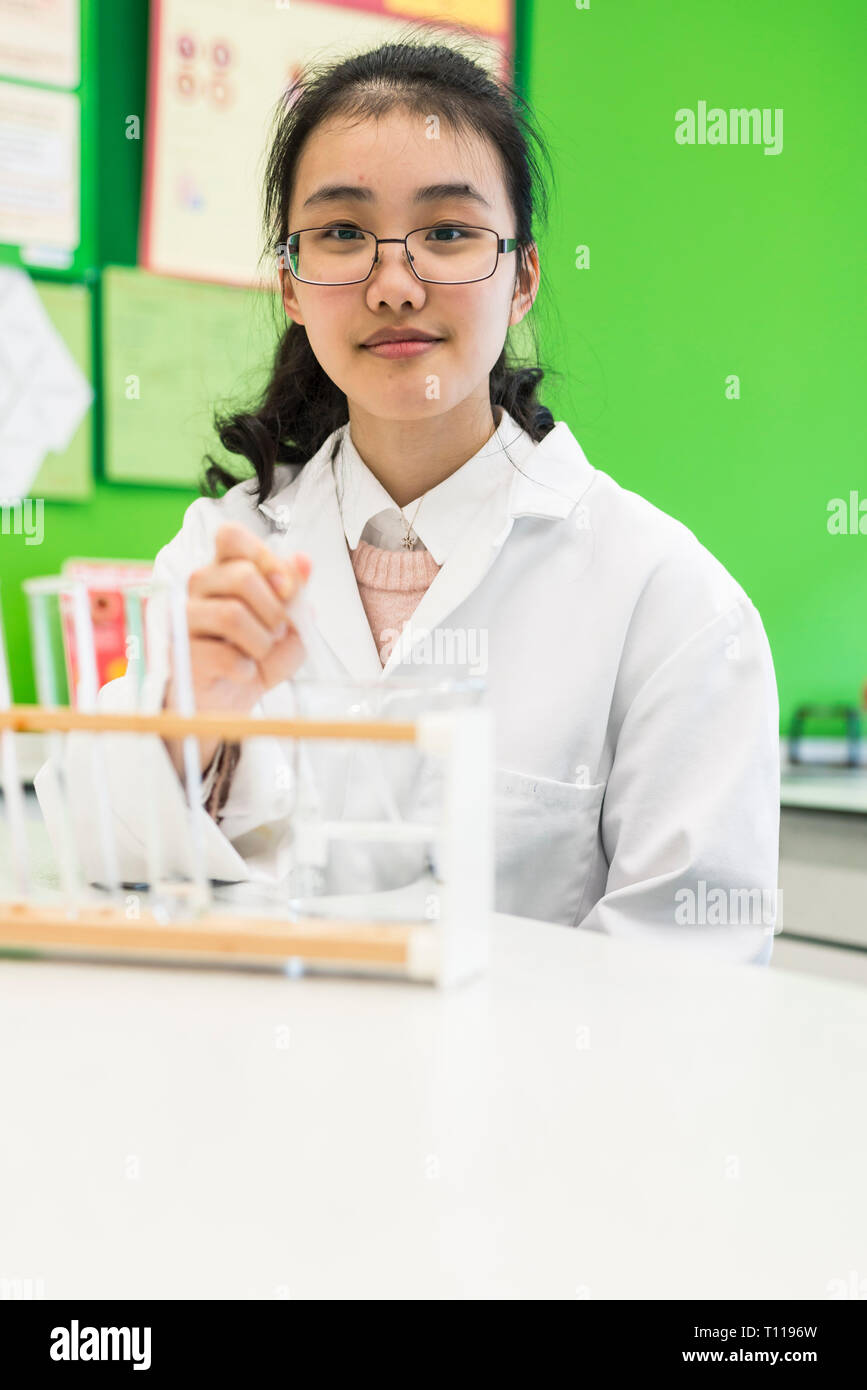 a female international asian student in the science lab of her college ...