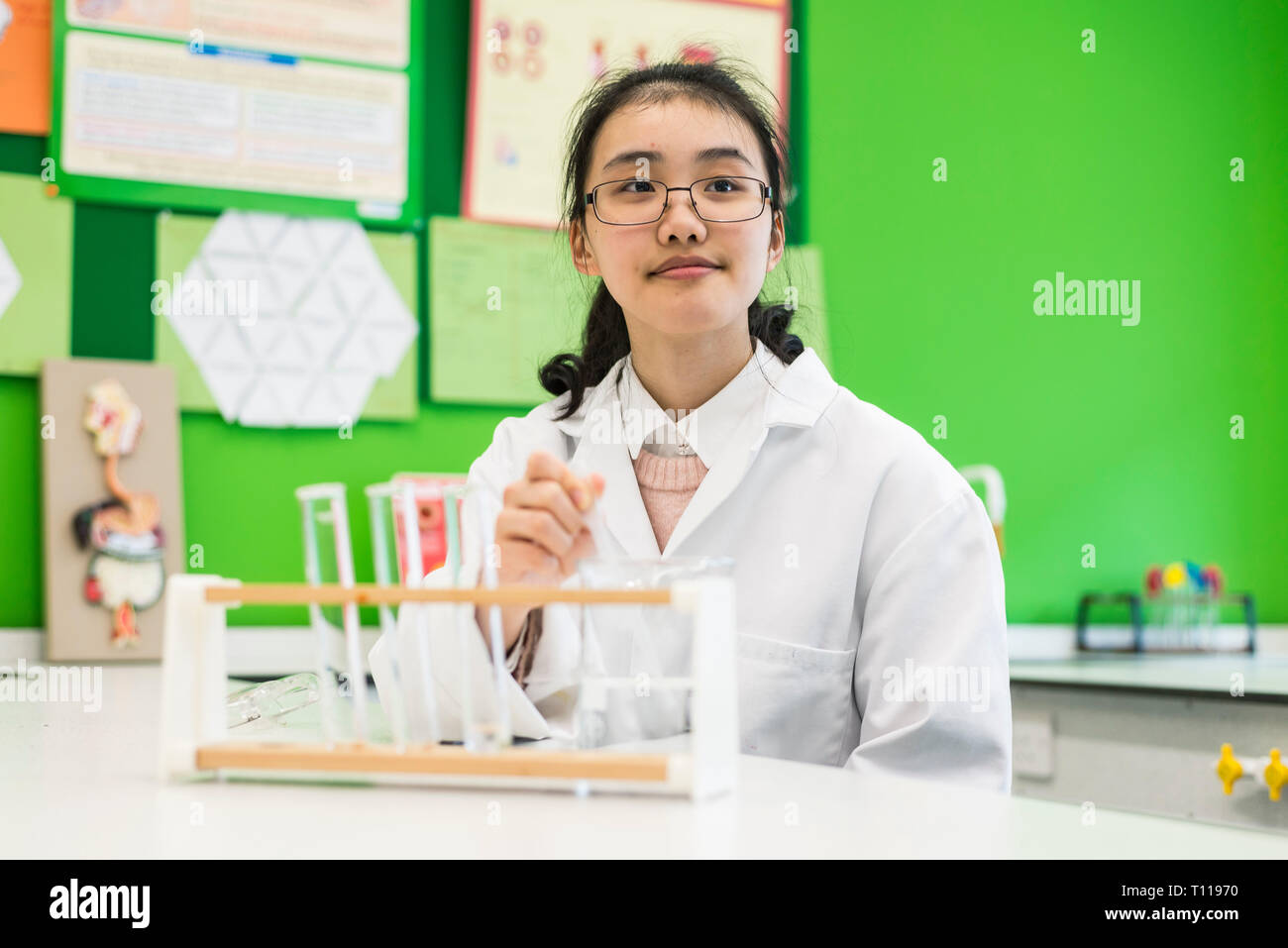 a female international asian student in the science lab of her college ...