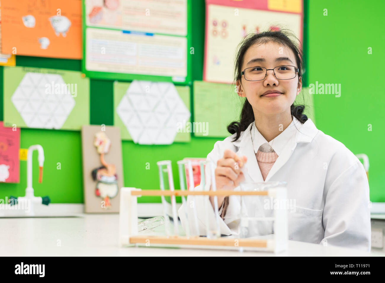 a female international asian student in the science lab of her college ...