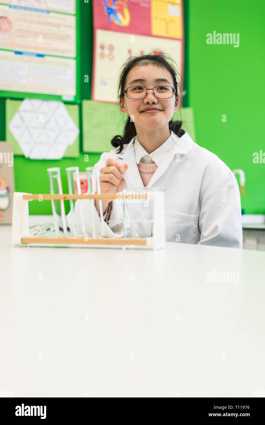 a female international asian student in the science lab of her college ...