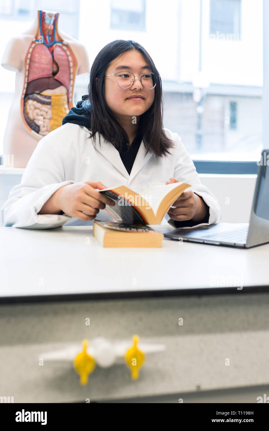 a female international asian student in the science lab of her college ...