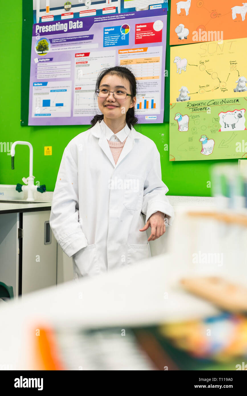 a female international asian student in the science lab of her college ...