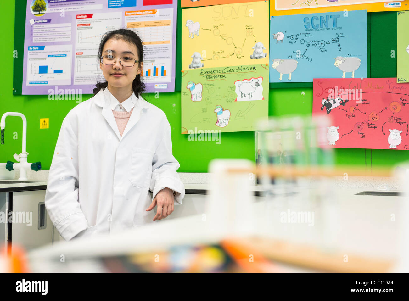 a female international asian student in the science lab of her college ...