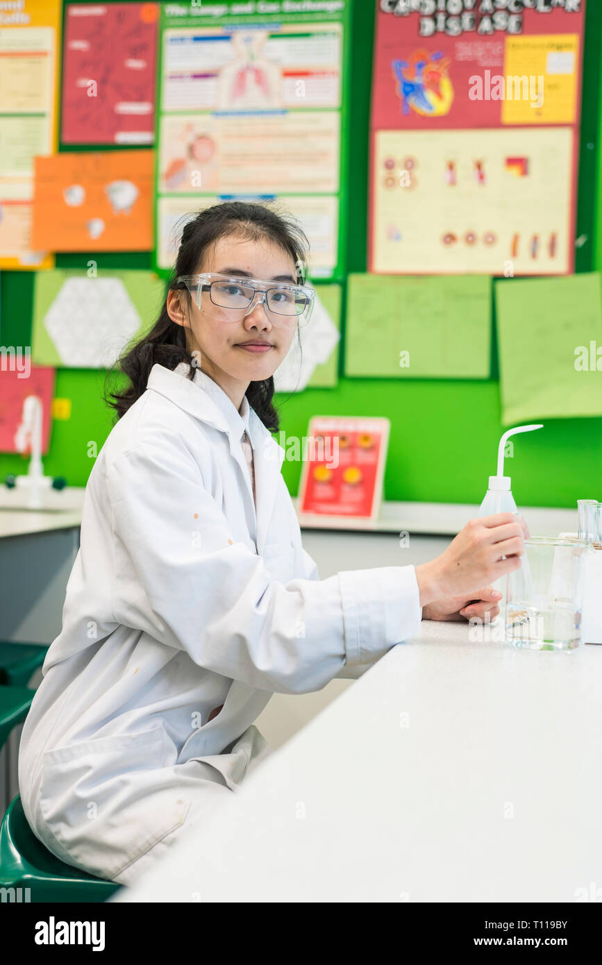 a female international asian student in the science lab of her college ...
