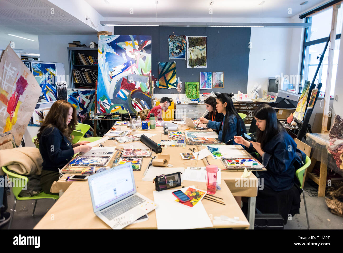 photos in an art lesson in the art class of a college with lots of ...