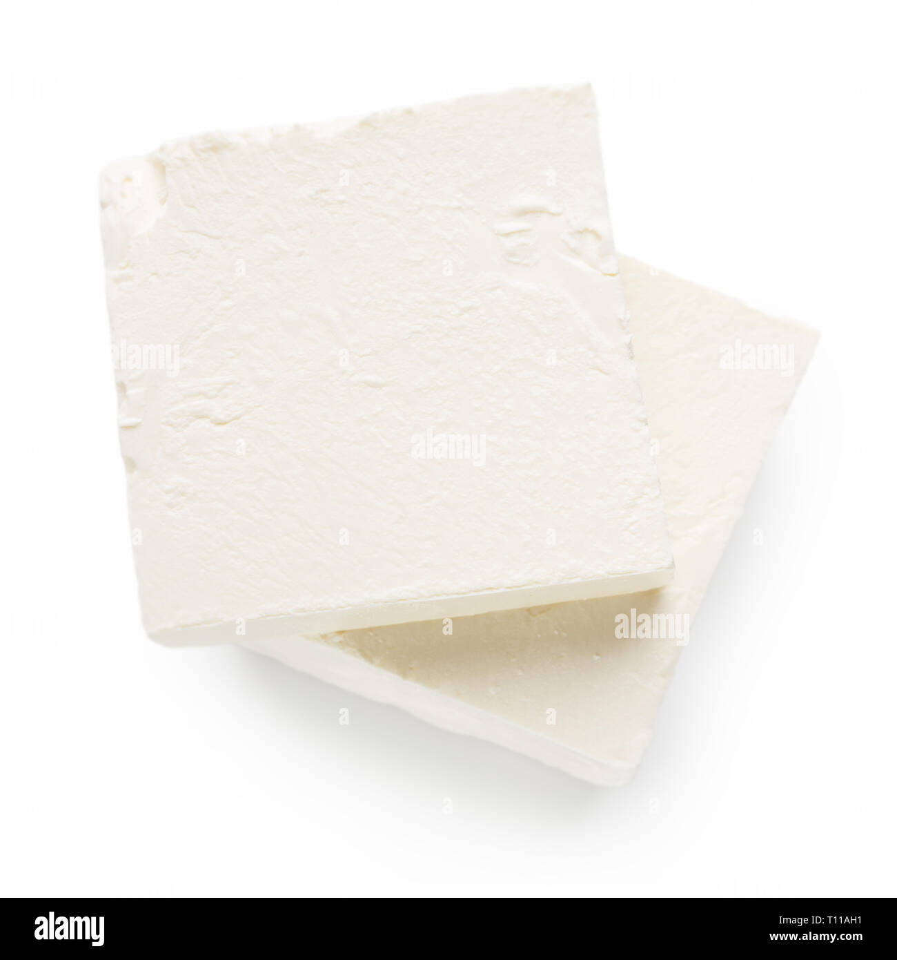 Feta cheese pieces isolated Cut Out Stock Images & Pictures - Alamy