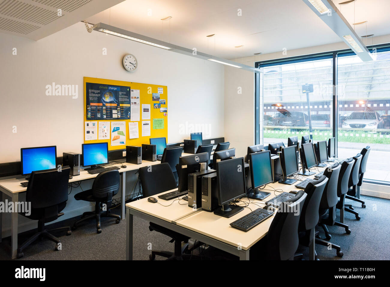 a bright modern empty classroom with lots of computers for learning ...