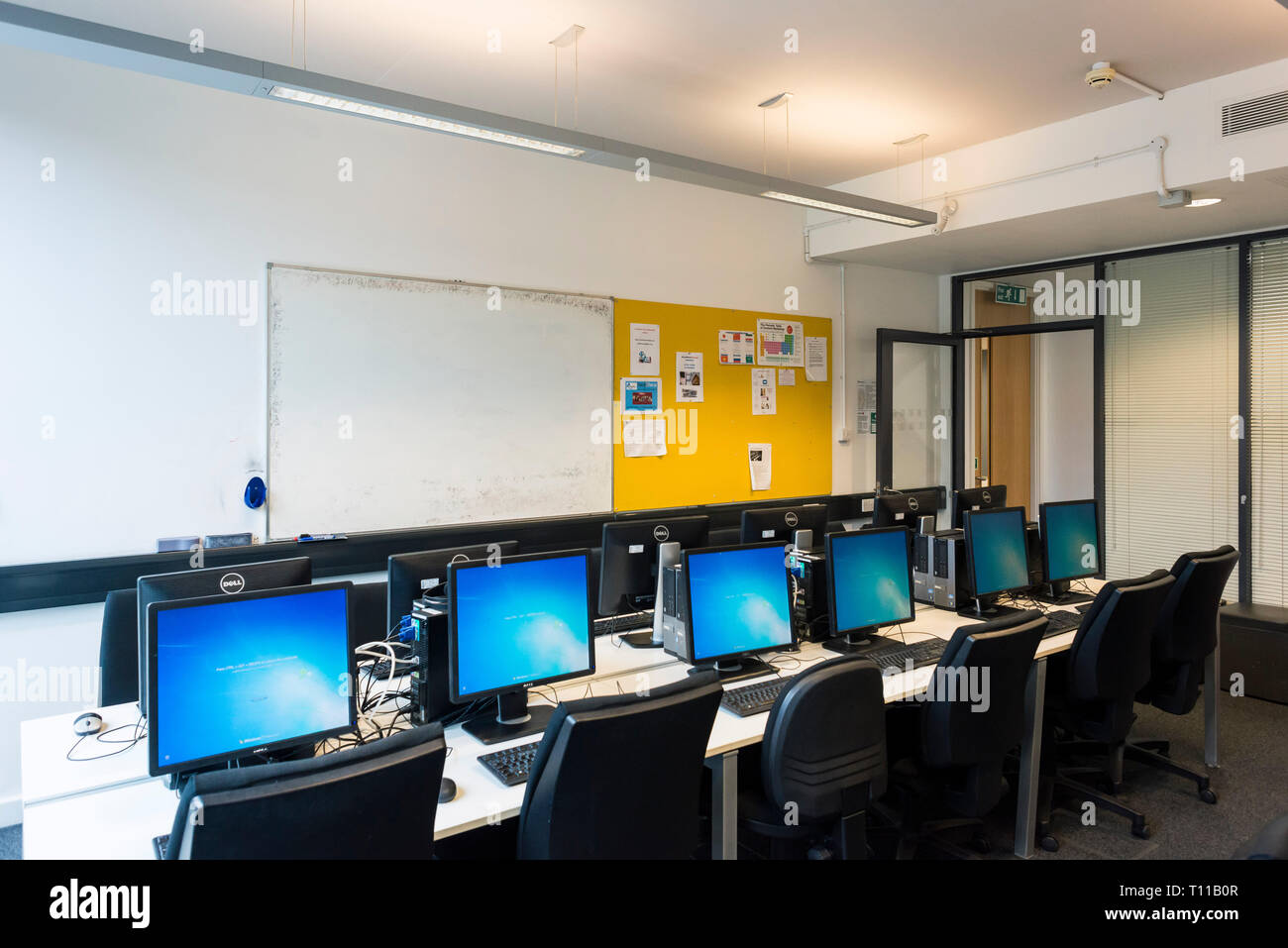 a bright modern empty classroom with lots of computers for learning ...