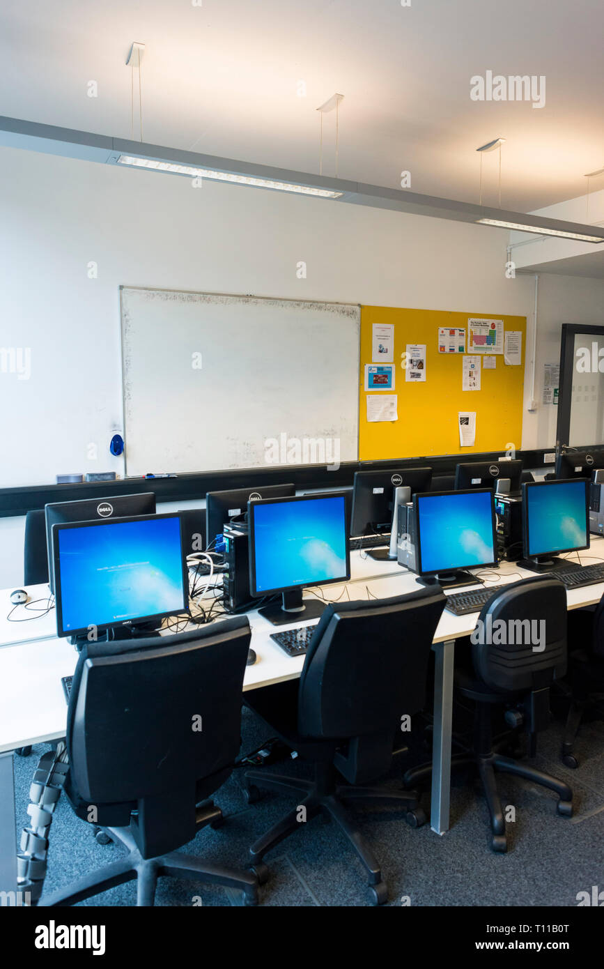 a bright modern empty classroom with lots of computers for learning ...