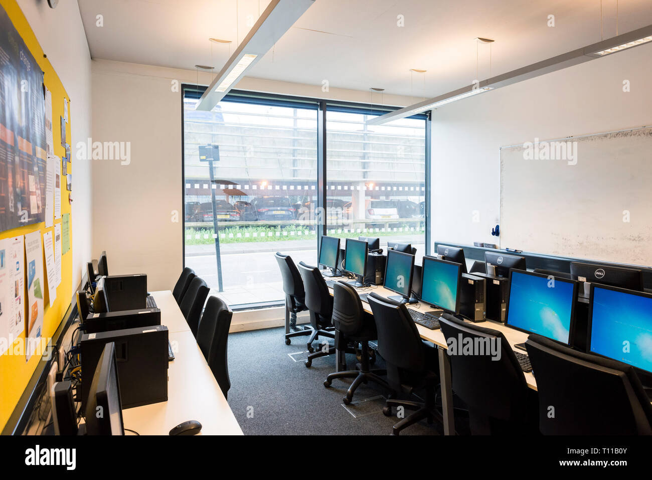 a bright modern empty classroom with lots of computers for learning ...