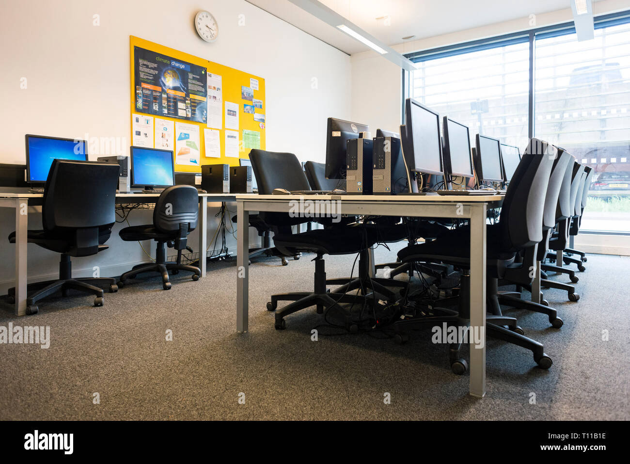 a bright modern empty classroom with lots of computers for learning ...