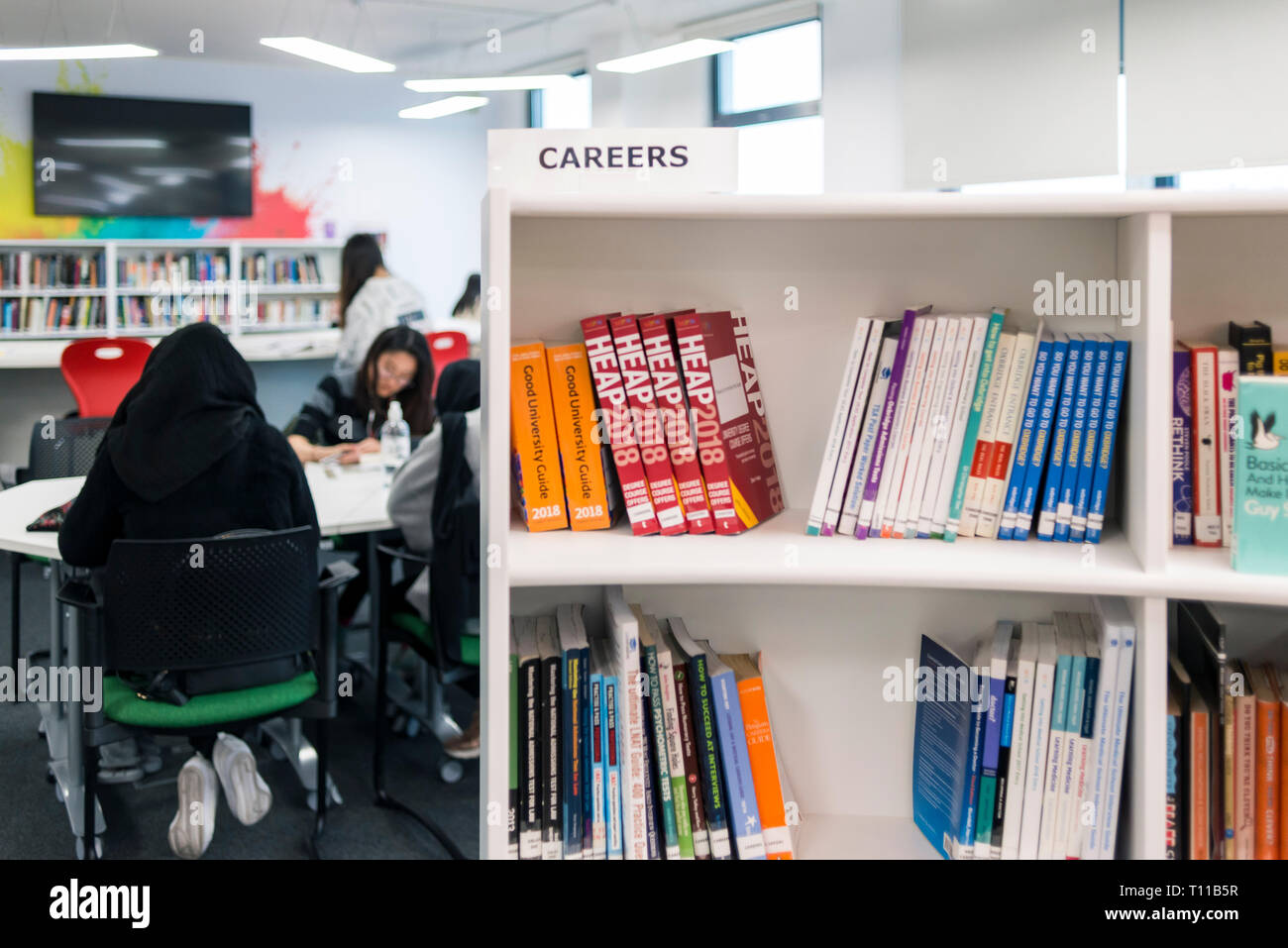 photos inside a college library with lots of students and books around ...