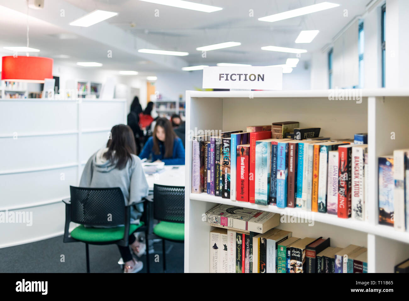 photos inside a college library with lots of students and books around ...