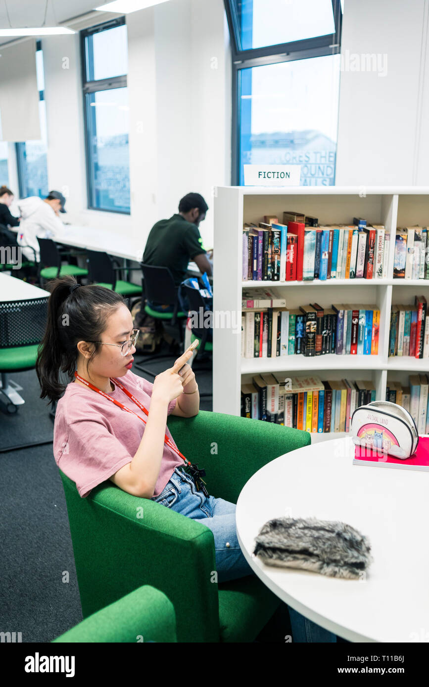 photos inside a college library with lots of students and books around ...