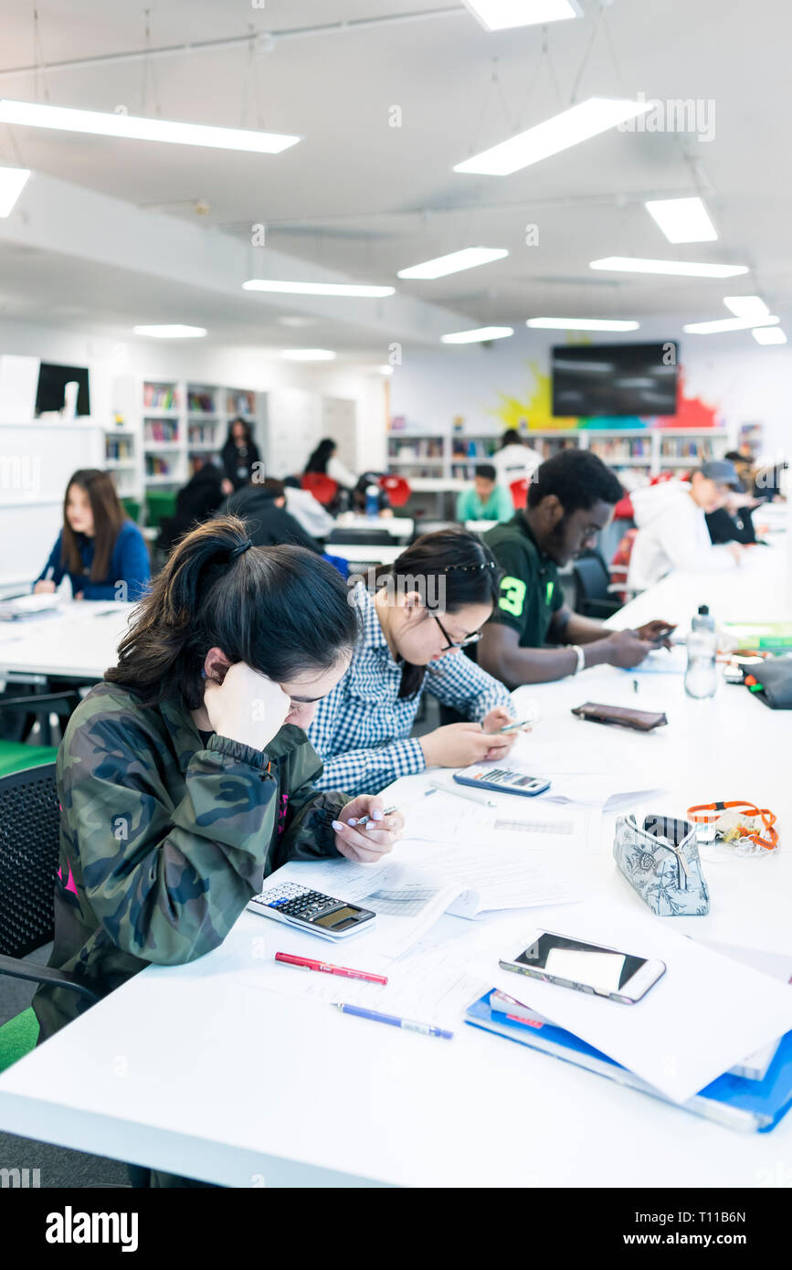 photos inside a college library with lots of students and books around ...