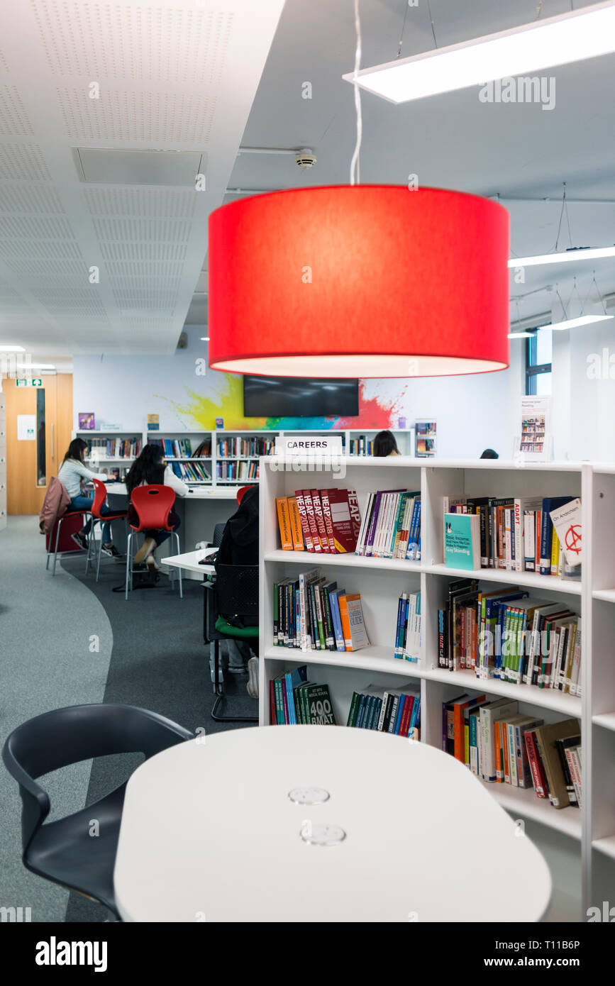 photos inside a college library with lots of students and books around ...