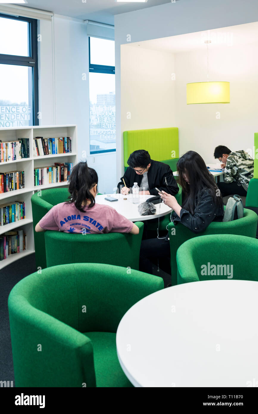 photos inside a college library with lots of students and books around ...