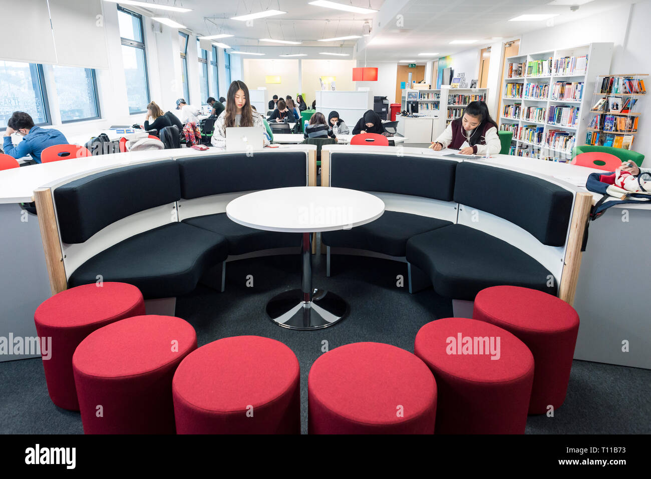 photos inside a college library with lots of students and books around ...