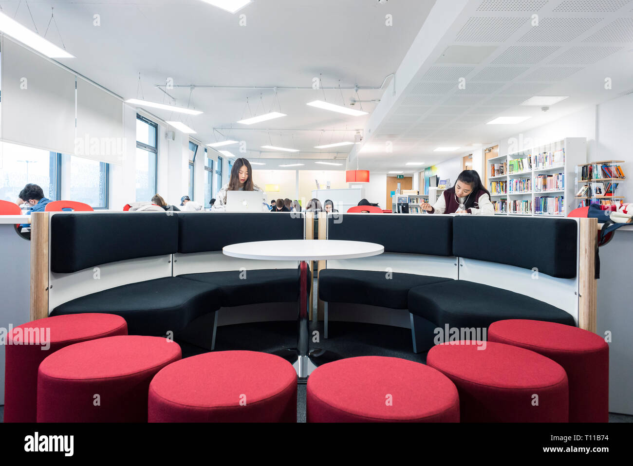 photos inside a college library with lots of students and books around ...