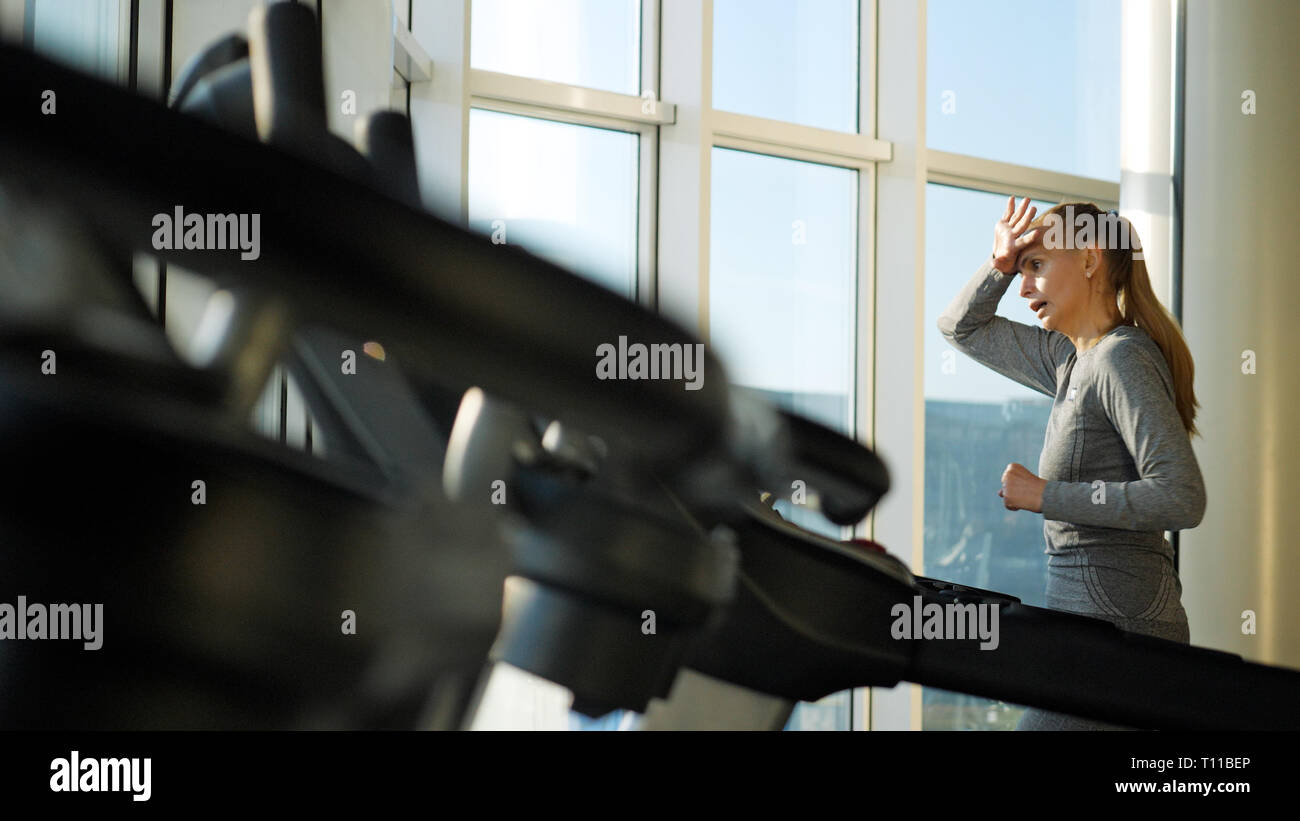 Woman of middle age working out in gym. Healthy lifestyle.Training on ...
