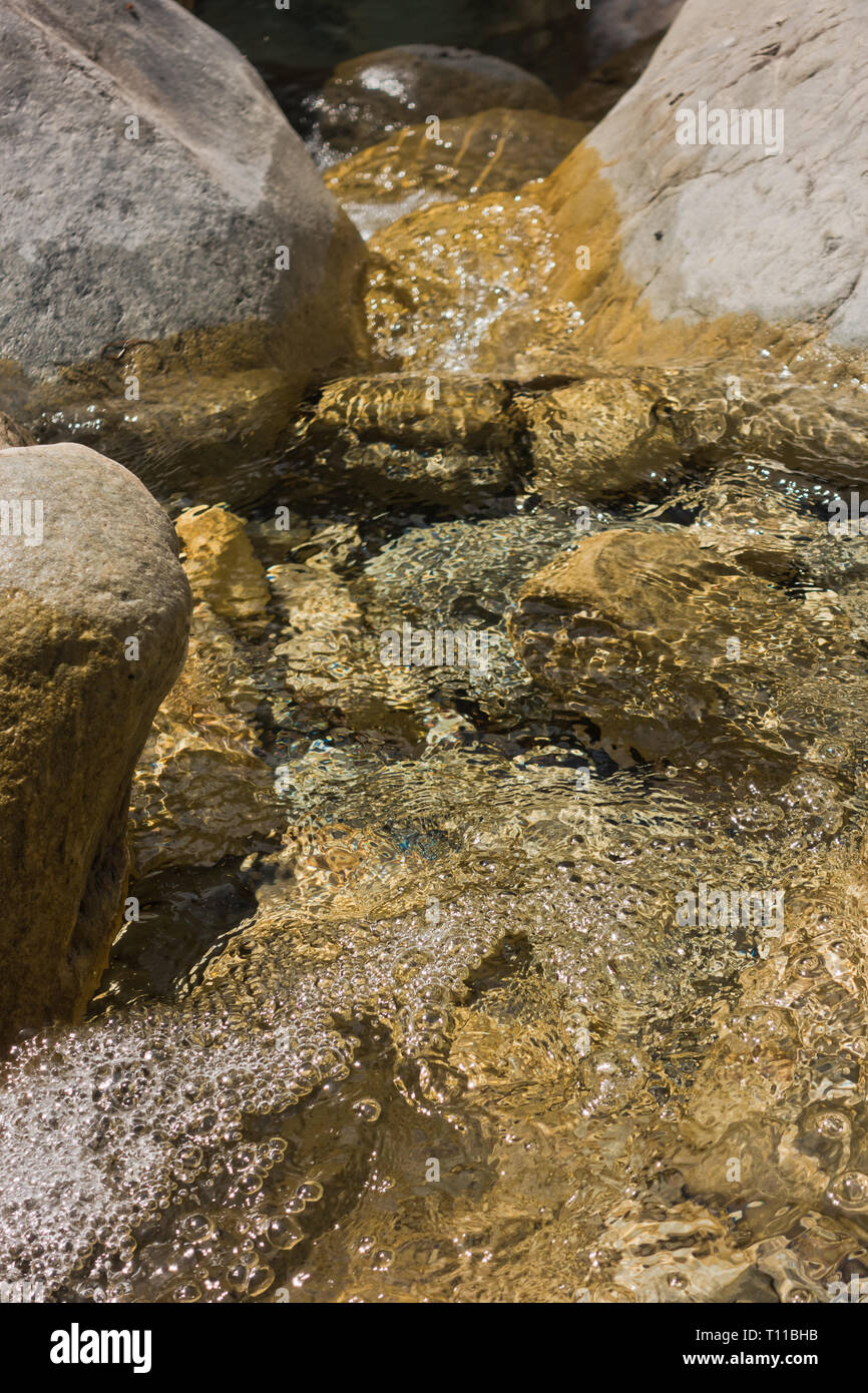 Crystal clear water of a cold mountain creek at rocky terrain of ...