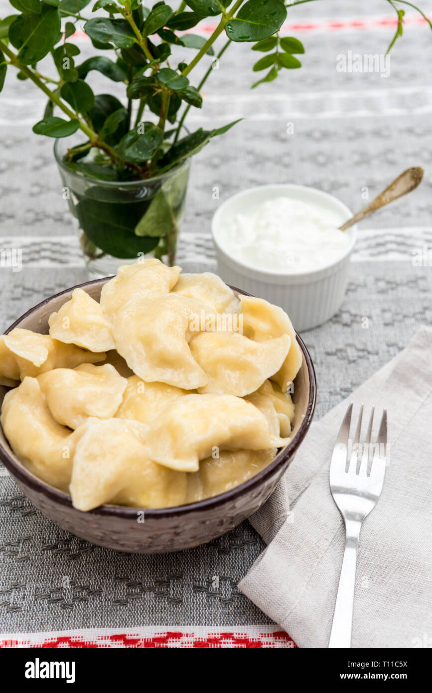 Vareniki with Smetana (Sour Cream) served on a table ready to eat Stock ...