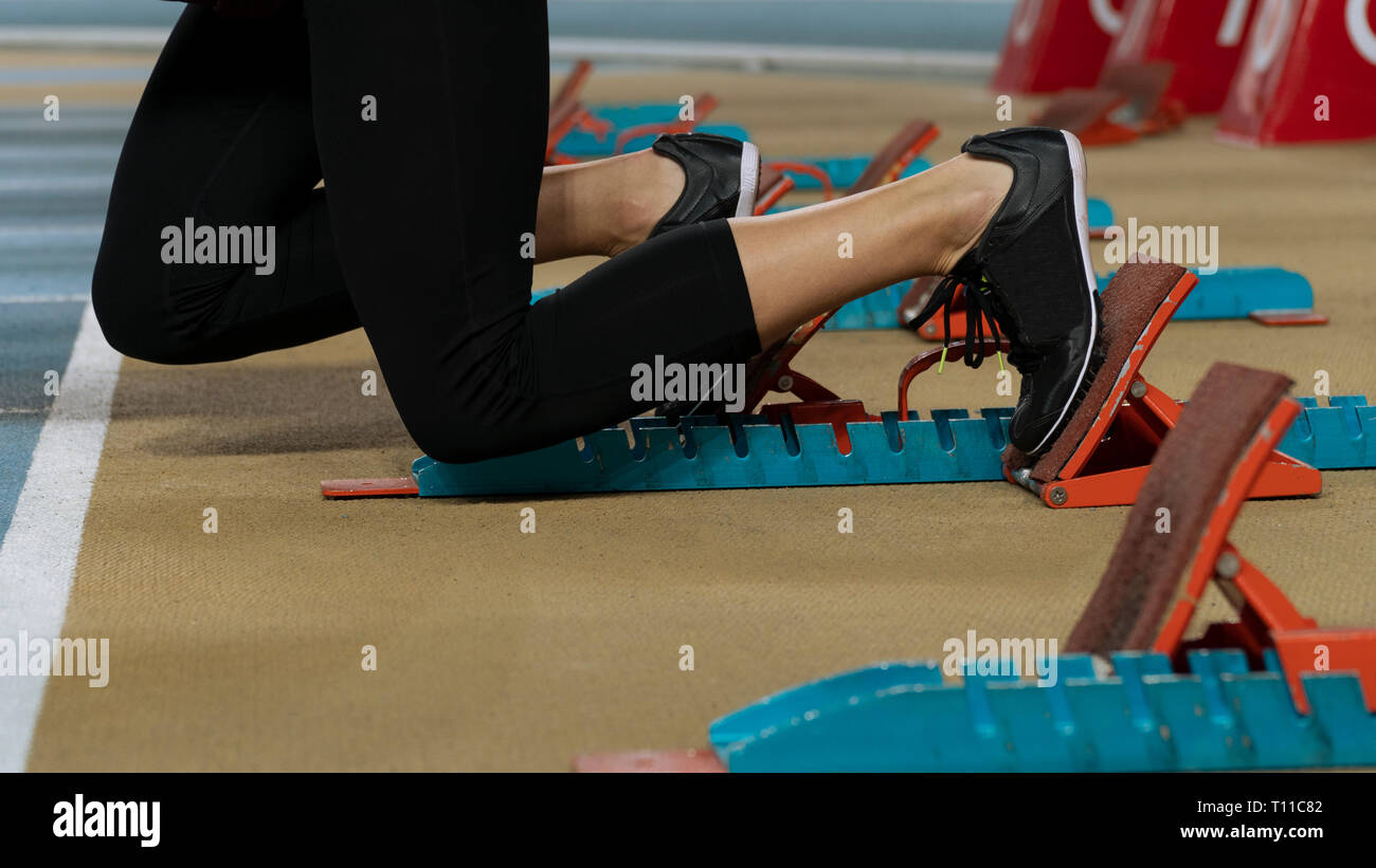 Action packed image of a female athlete leaving the starting blocks for ...