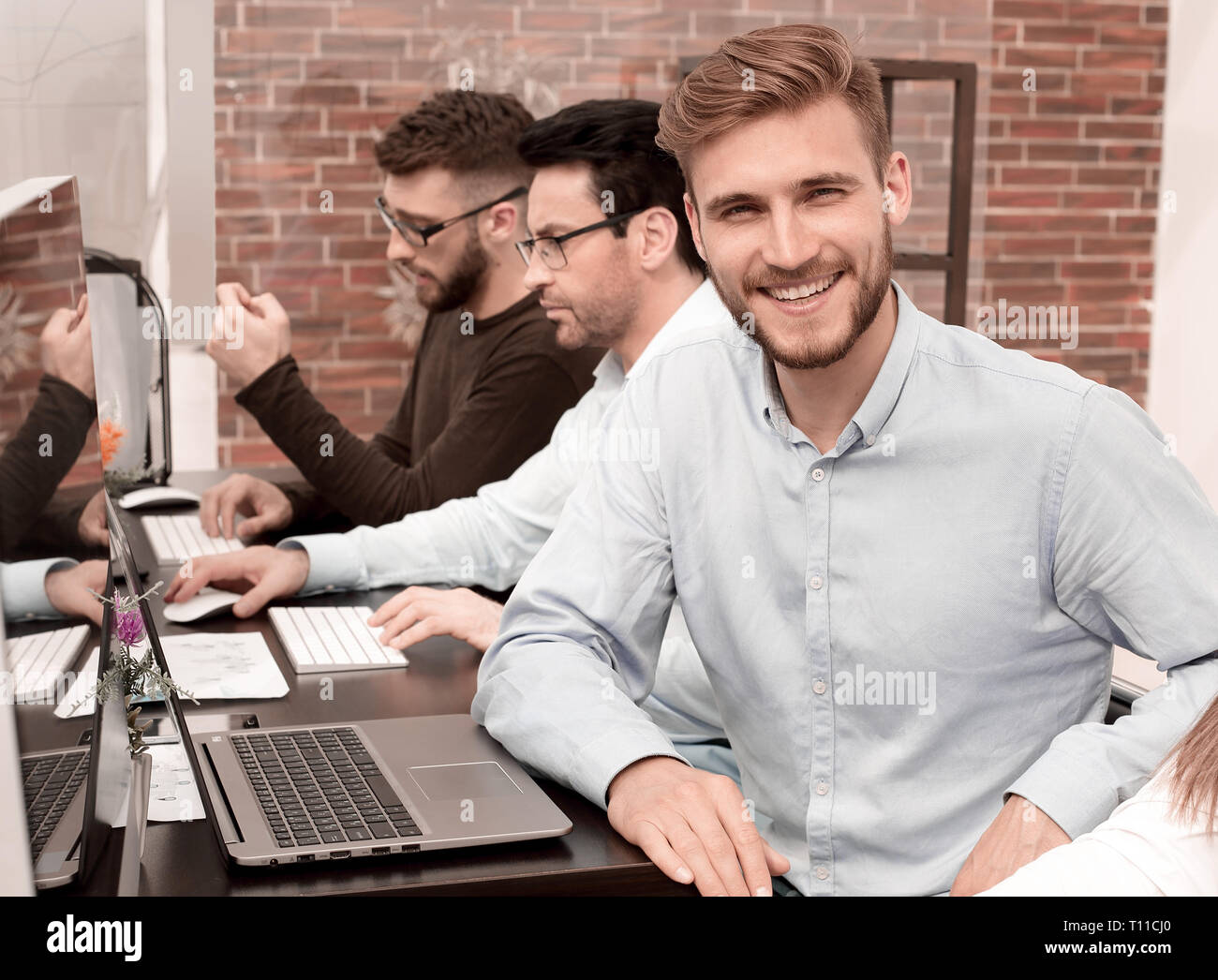 smiling employee of the business center in the workplace Stock Photo ...
