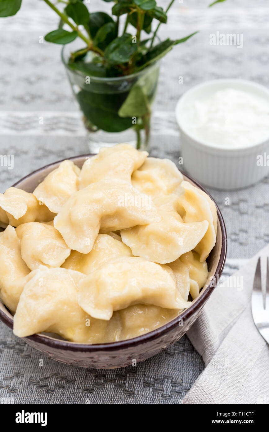 Vareniki with Smetana (Sour Cream) served on a table ready to eat Stock ...