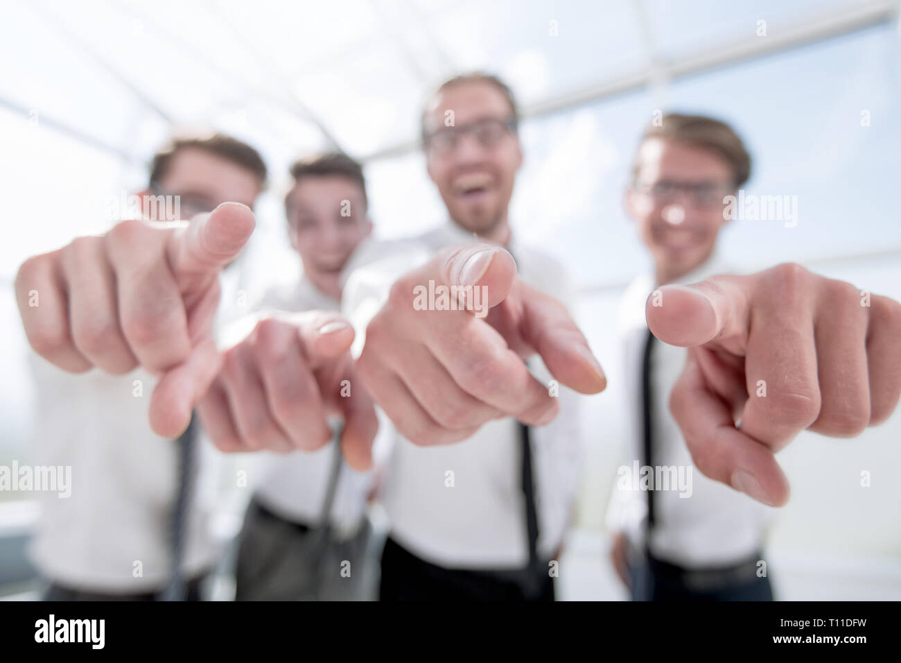 business background.happy employees pointing at you Stock Photo - Alamy