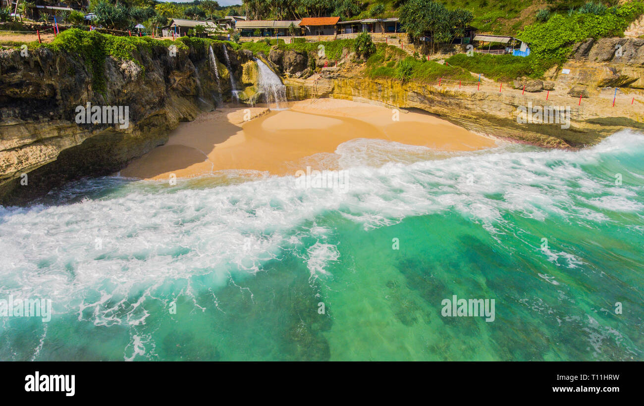 When freshwater meet salt water. A small waterfall, Banyu Tibo plunge ...